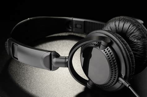 Premium Photo Black Headphones On A Black Surface