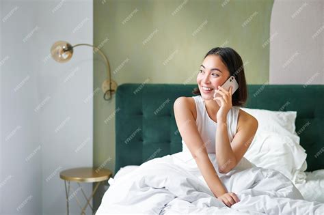 Premium Photo Beautiful Smiling Asian Girl Talking On Mobile Phone