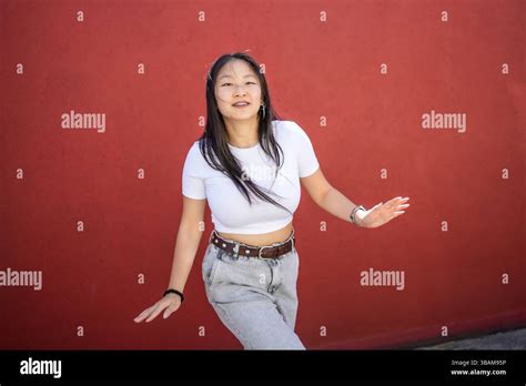 Cute Urban Female Asian Artist Dancing K Pop Dance Smiling At Camera