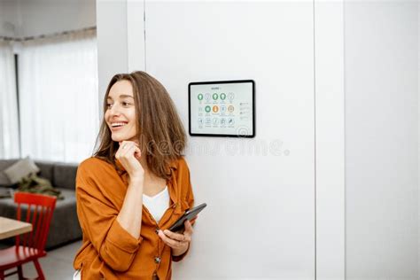 Woman Controlling Smart Devices With A Digital Tablet At Home Stock