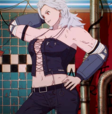 A Woman With White Hair Standing In Front Of A Tiled Wall And Holding Her Hand On Her Hip