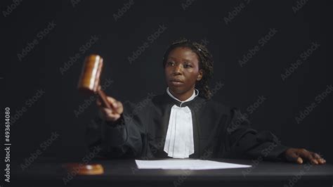 Confident African American Female Judge Tapping Gavel Announcing Court
