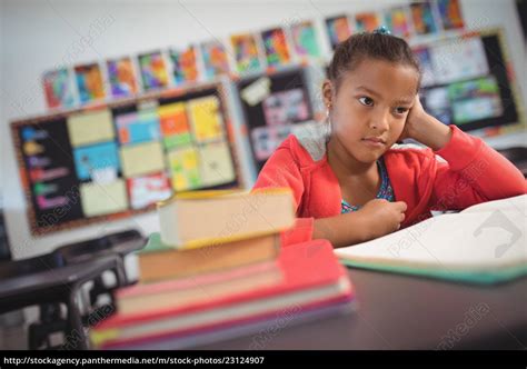 Nachdenkliches Schulmädchen Am Schreibtisch Sitzen Lizenzfreies Bild