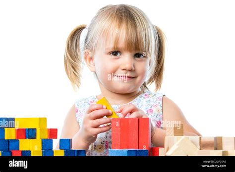 Close Up Portrait Of Infant Playing Building Game With Wooden Blocks At
