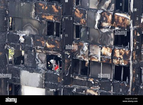 A Firefighter Investigates A Floor After A Fire Engulfed The 24 Storey