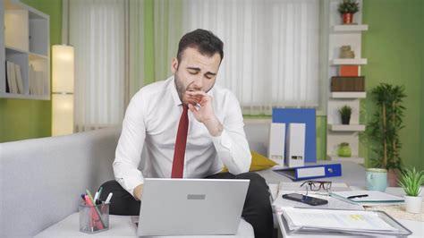 Home Office Worker Who Is Sleepy Due To Exhaustion Is Trying Not To