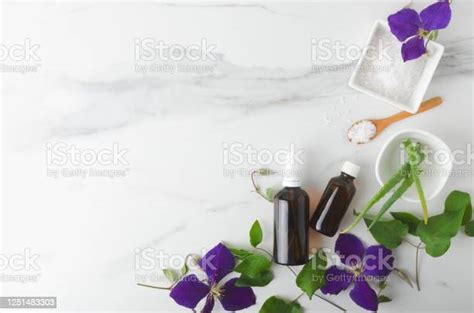 화장품 제품 녹색 잎과 보라색 꽃 바다 소금 그릇 흰색 대리석 표면에 알로에 의 유리 병의 상단 보기 빈 공간 0명에 대한 스톡