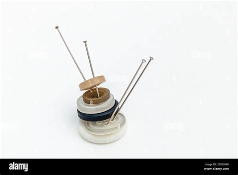 Horizontal Photo Buttons Stacked With Pins On White Background Copy Space Concept Hobbies