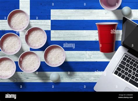 Greece Flag Concept With Plastic Beer Pong Cups And Laptop On National