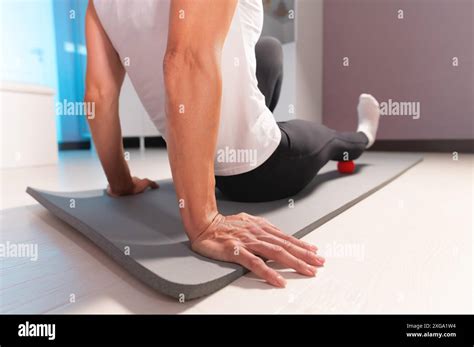Caucasian Woman Doing Myofascial Foot Massage With Massage Red Ball