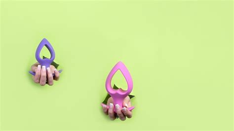 Premium Photo Sex Toys On A Green Background Copy Space