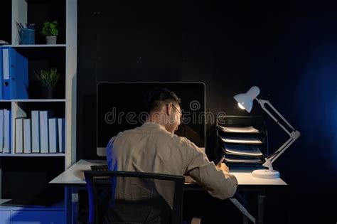 Overworked Young Asian Office Employee Working On Laptop Computer