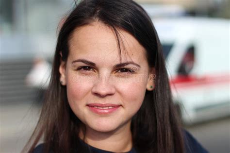Long Haired Brunette Girl Smiling In The Square On The Background Of An