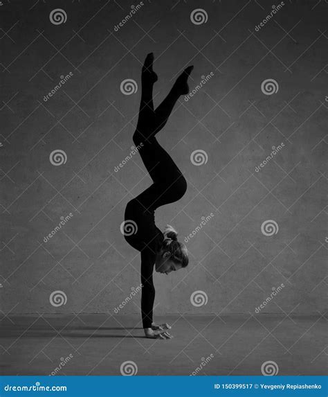 Flexible Gymnast Girl In A Beautiful Pose On A Background Of