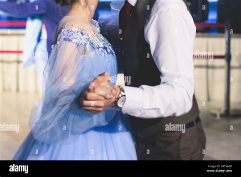High School Graduates Dancing Waltz And Classical Ball Dance In Dresses And Suits On A School