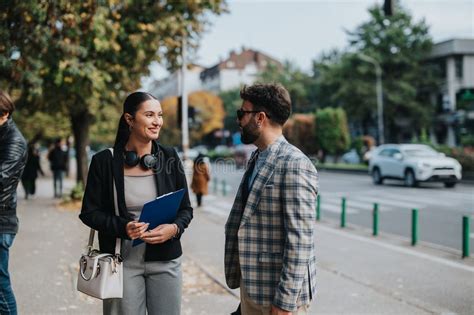 Two Business People Having A Conversation On A City Street Stock Image