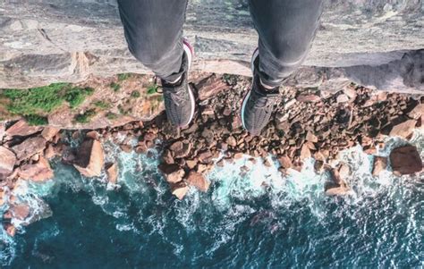 Premium Photo Low Section Of Person Dangling Legs Over Sea