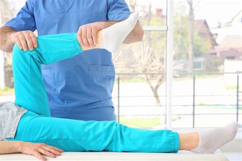 Premium Photo Physiotherapist Working With Patient In Clinic