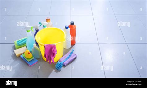 Assorted Cleaning Supplies And Detergents On The Bathroom Floor