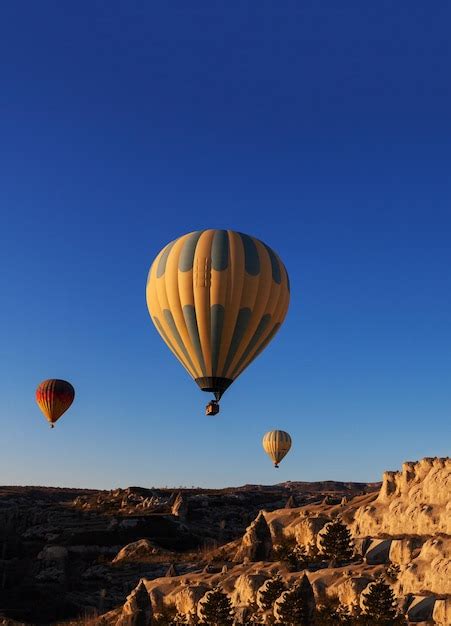 Premium Photo Hot Air Balloon Rises Very High In Blue Sky Above White
