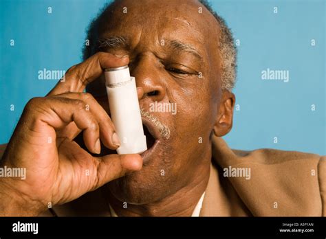 Adult Male Uses Inhaler To Treat His Asthmatic Condition Stock Photo Alamy