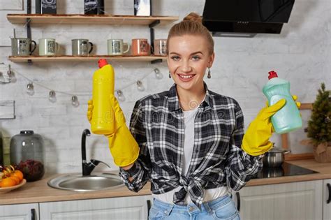 Woman Comparing Detergent Products She Is Holding Two Bottles And