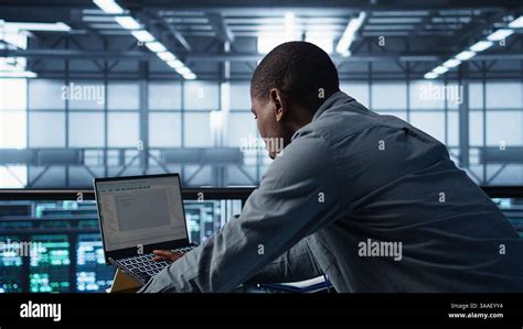 Technician In Data Center Using Laptop Adjusting Power Management Settings Using Programming