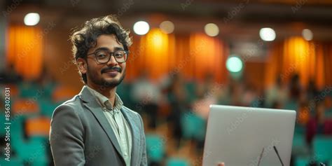 Software Developer Using Laptop Computer And Delivering A Motivational Speech On Stage Stock