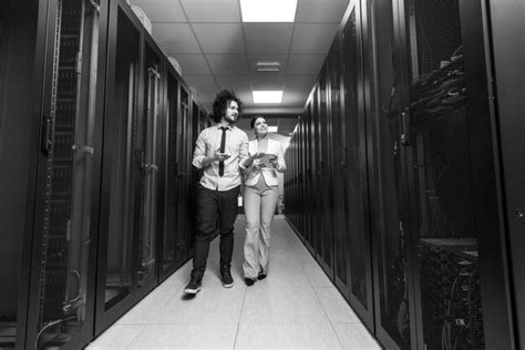 Premium Photo Young It Engineer Showing Working Data Center Server Room To Female Chief