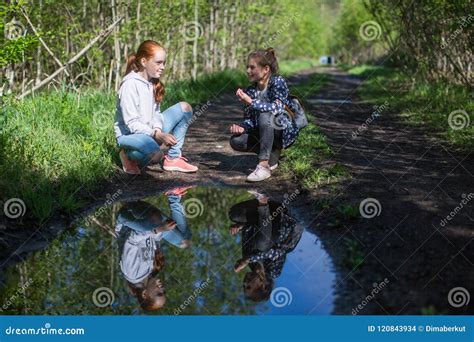 Two Young Girls Or Girlfriends Are Talking Emotionally In The Park