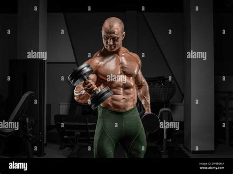 Professional Weightlifter Is Training In The Gym Dumbbell Curl
