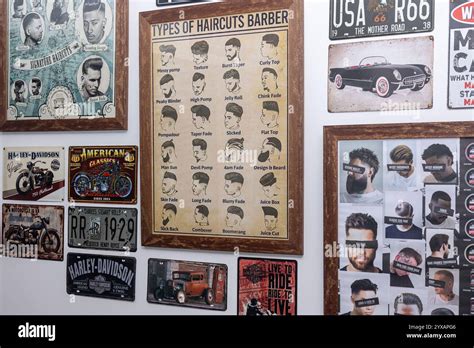A Barber Shop Wall Featuring Framed Haircut Style Charts Vintage Signs And Retro Artwork
