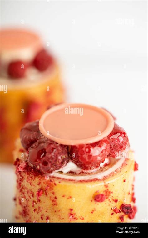 A Delicious Dessert Of Raspberry Pudding Topped With Luscious Cream And