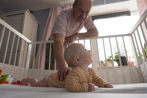 Premium Photo Portrait Of A Cheerful Mature Grandfather Playing With