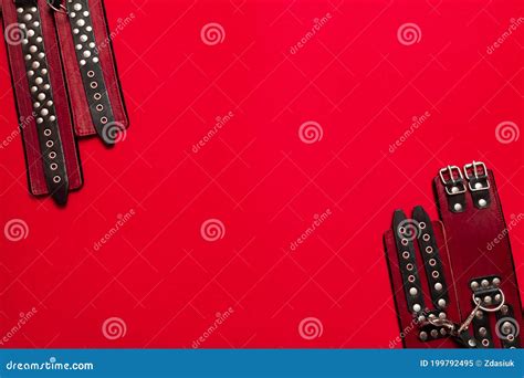 Red Color Banner With Black Leather Bracers And Metal Rivets For Shackling Hands Or Legs And
