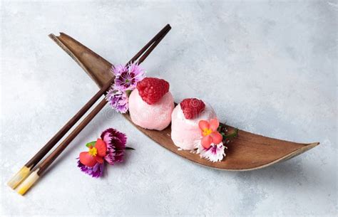 Raspberry Dessert Mochi On A Bamboo Stand Decorated With Live Edible Flowers Stock Image