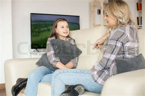 Mother And Daughter Boding While Sitting On The Couch Stock Image