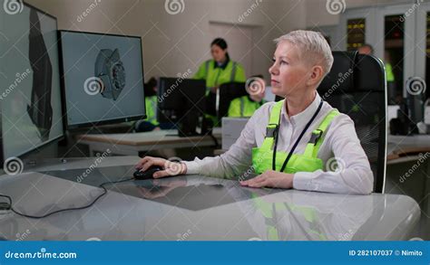 mature woman engineer working on desktop computer in cad software with