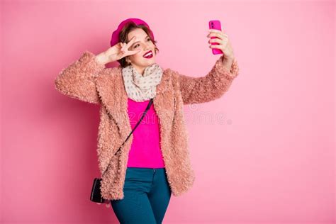 Photo Of Pretty Traveler Lady Hold Telephone Taking Funny Selfies Showing V Sign Near Eye Flirty