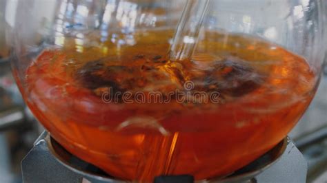 Amber Orange Liquid Is Boiling And Bubbling In A Glass Flask Chemical Lab Stock Footage Video