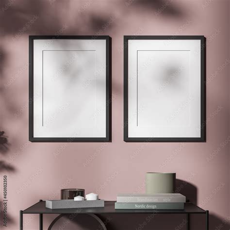 Two Vertical Blank Canvases In A Black Frame On The Background Of The