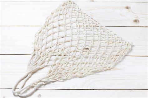 Premium Photo Top View Of Empty Yellow String Bag On White Wooden