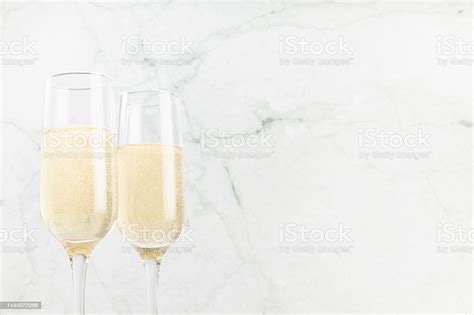 흰색 부드러운 빛 대리석 배경 근접 촬영 상단 부분에 두 잔에 반짝이는 샴페인이 있는 축제 배경 축하 이벤트 복사 공간을위한