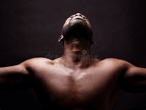 Revelling In His Strength Studio Shot Of A Muscular Man With