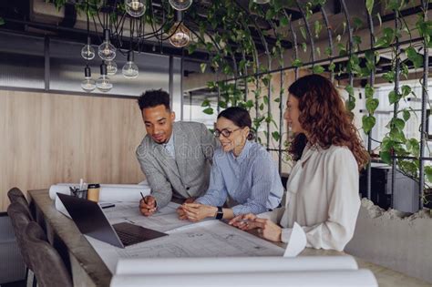 Engaging In A Collaborative Team Meeting Within A Modern And Innovative Workspace Setting Stock