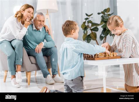 Selective Focus Of Brother And Sister Playing Chess While Their