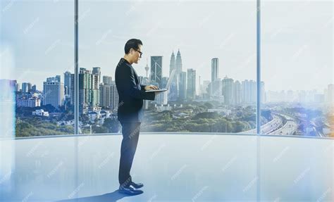 Premium Photo Businessman Using Laptop With Generic Office Background