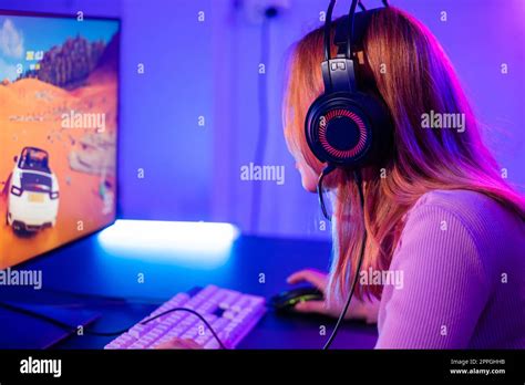 Young Player Woman Wearing Gaming Headphones Intend To Do Playing Live