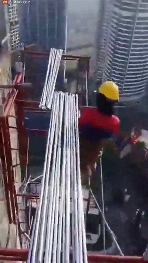 Crazy Men Work On High Rise Scaffolding Without Harness Or Safety Belt