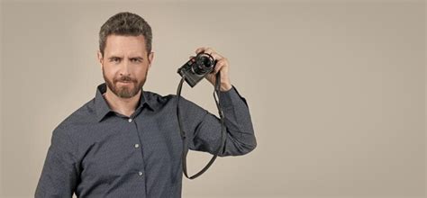 Premium Photo Bearded Man In Casual Shirt Hold Film Camera Grey